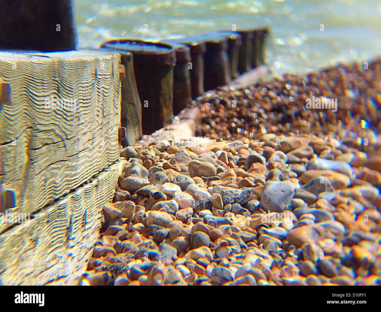 Wood grain of groynes against shingle beach Stock Photo - Alamy