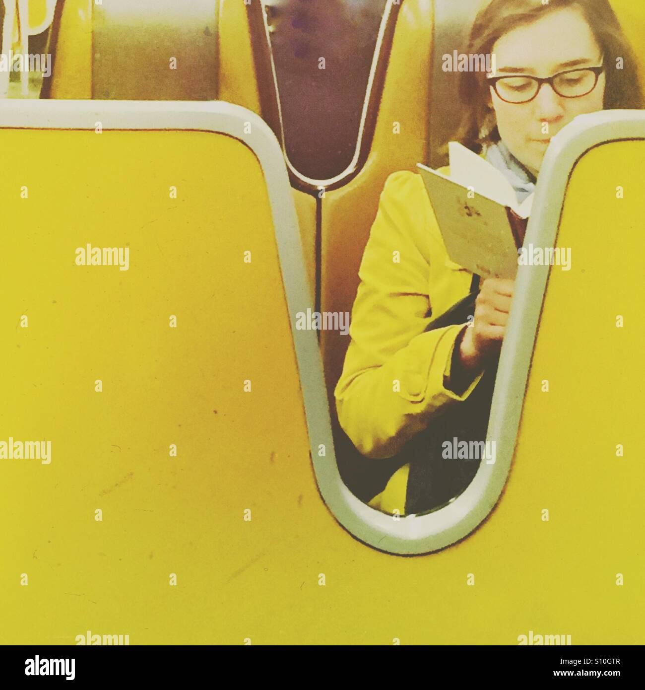 Woman reading on the subway Stock Photo - Alamy