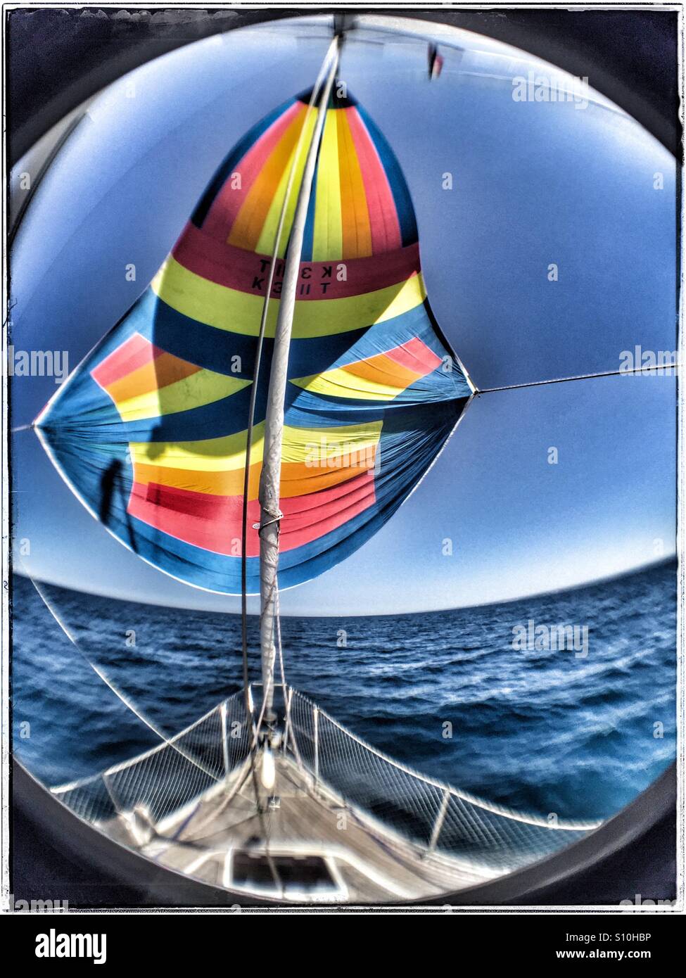 Downwind sailing with a multicoloured spinnaker sail, fisheye lens view ...
