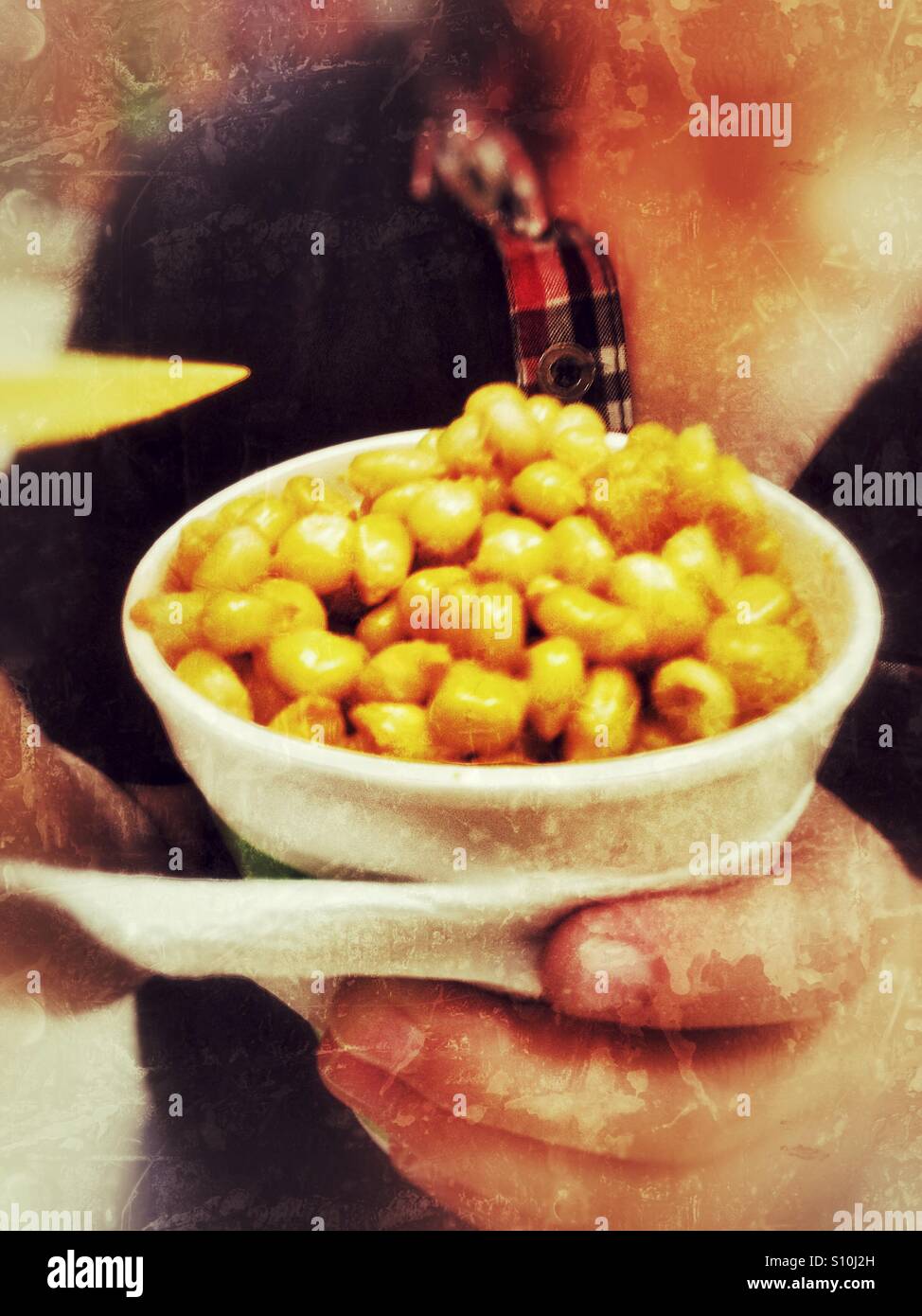 Eating a cup of sweetcorn as a healthy snack Stock Photo - Alamy