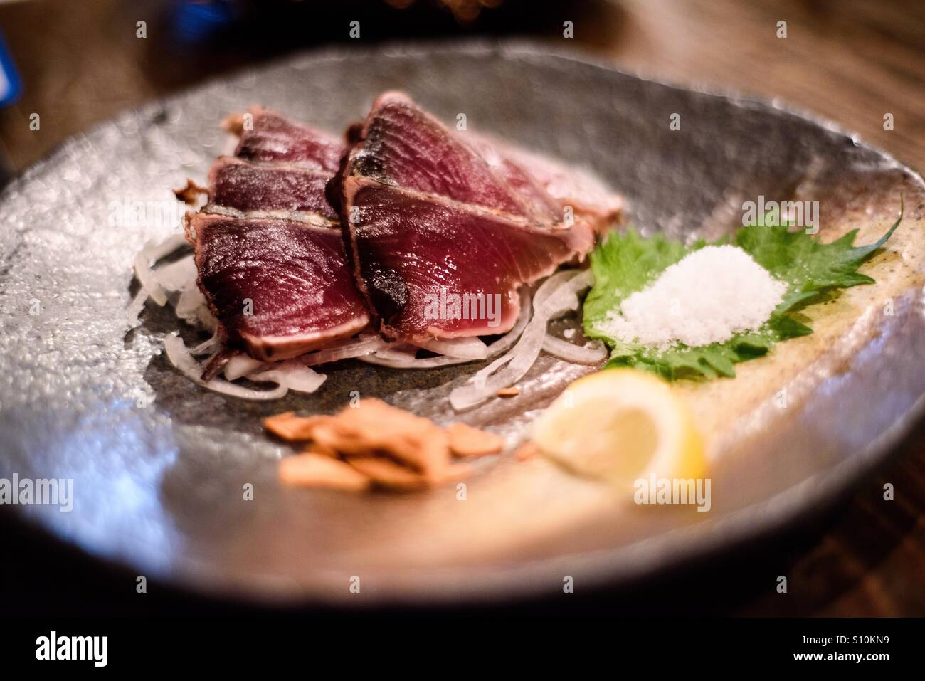 A plate of Japanese raw fish specialty served in traditional style ...