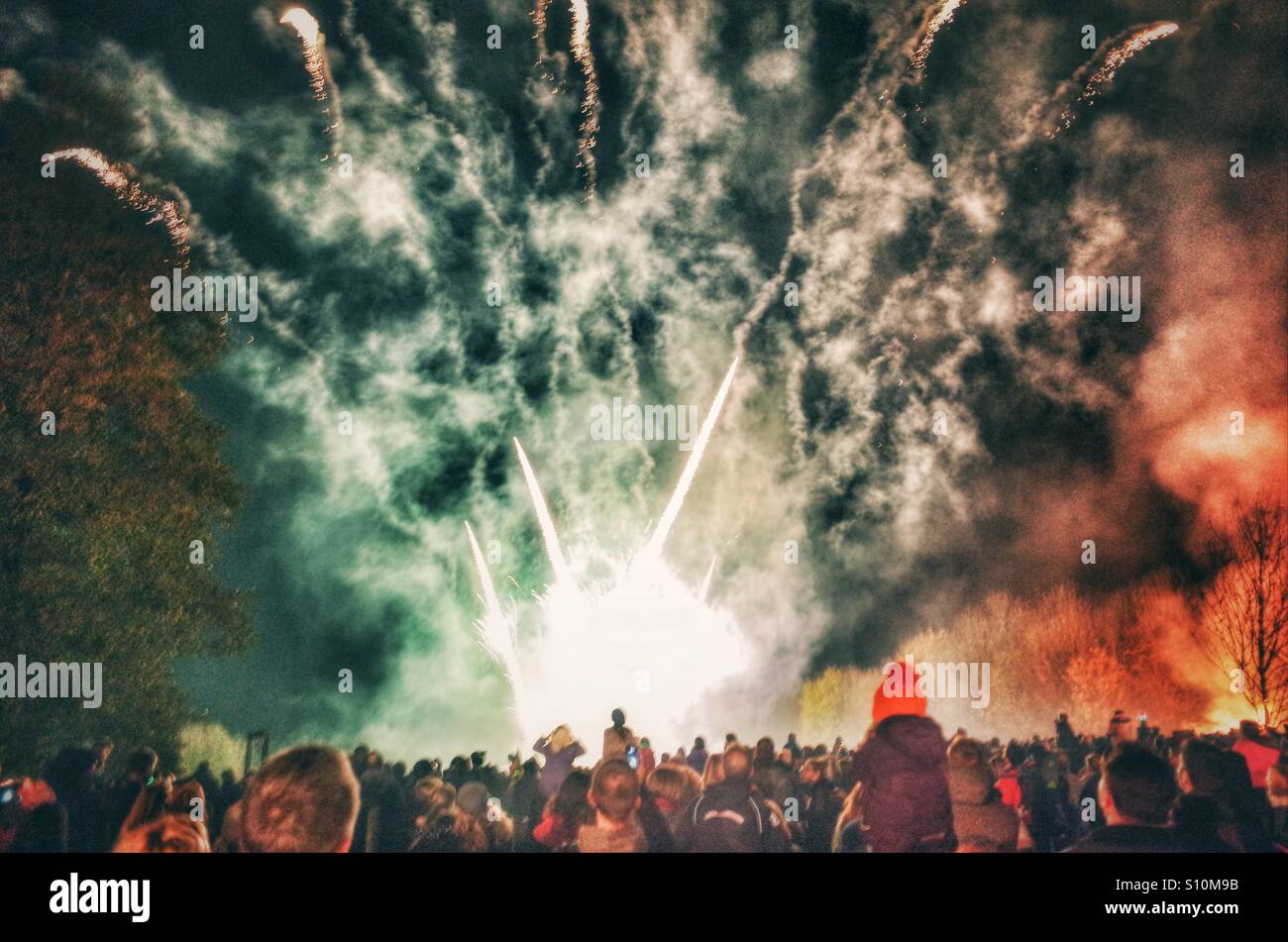 Crowd watches firework display Stock Photo - Alamy