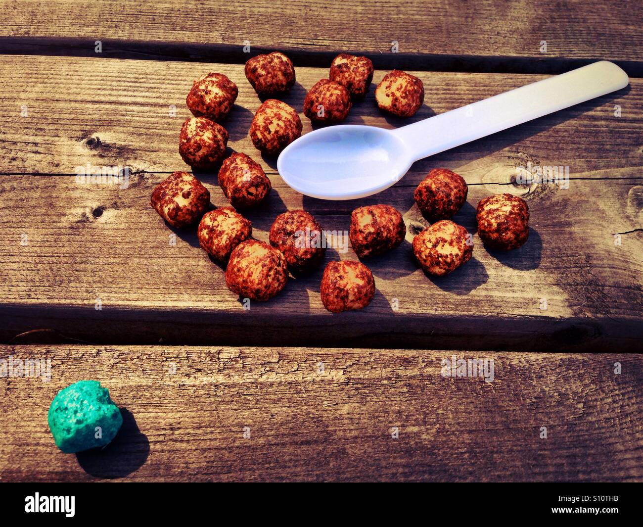 The brown snack balls huddle around the spoon, wondering what it is ...