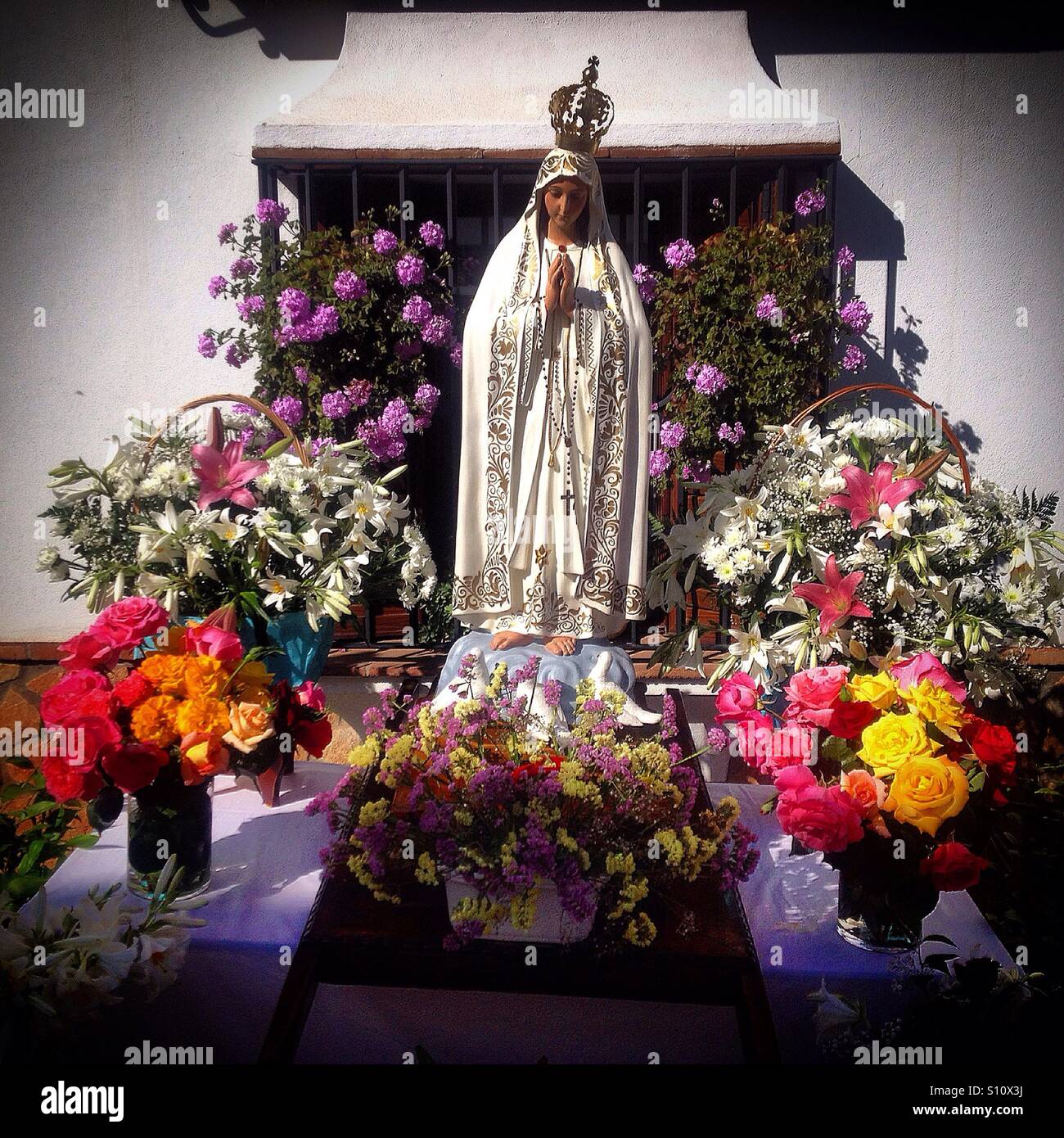 An altar with an image of the Virgin of Fatima decorates a street in El ...