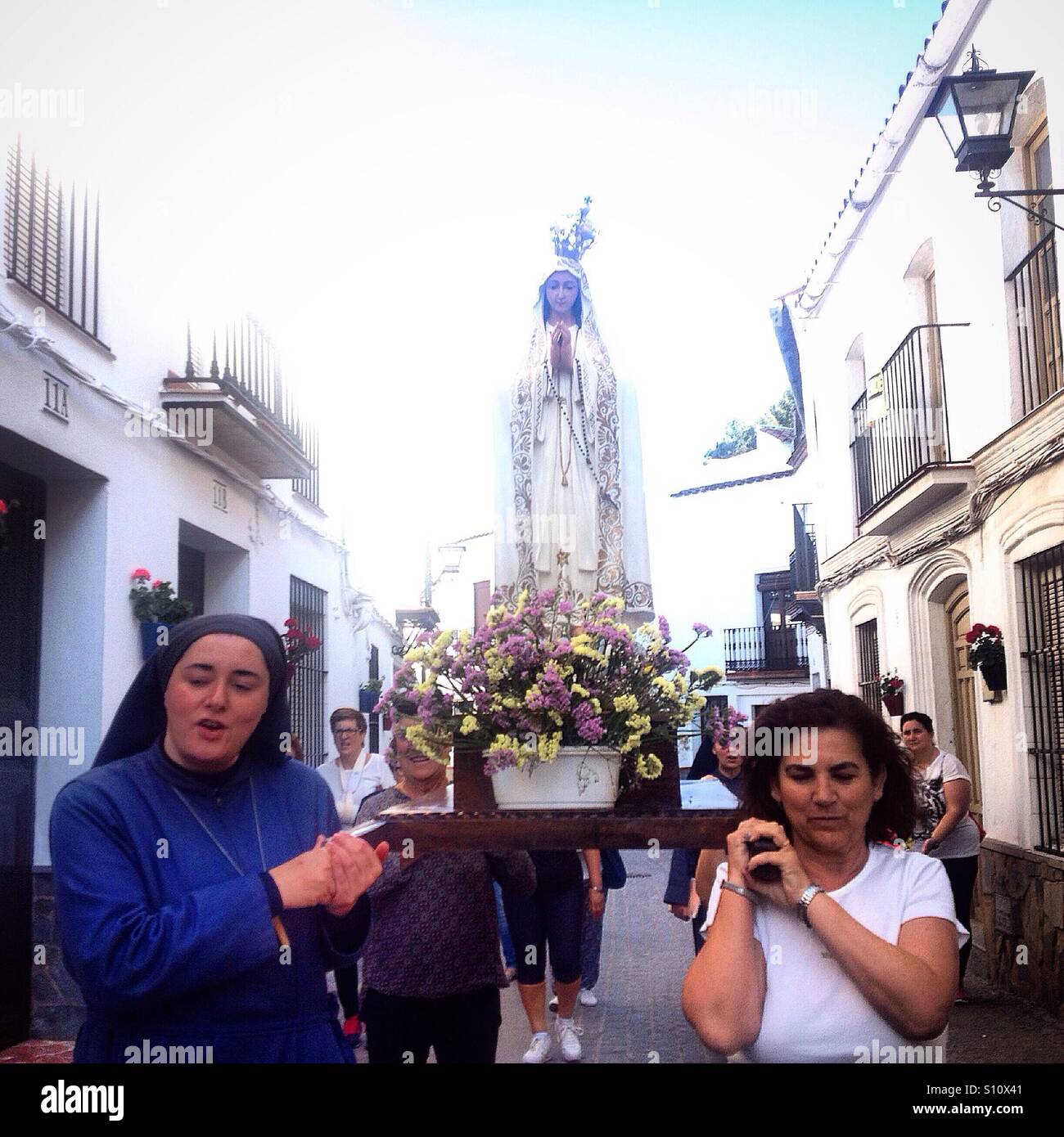 A nun helps locals to carry an image of Our Lady of Fatima during a ...
