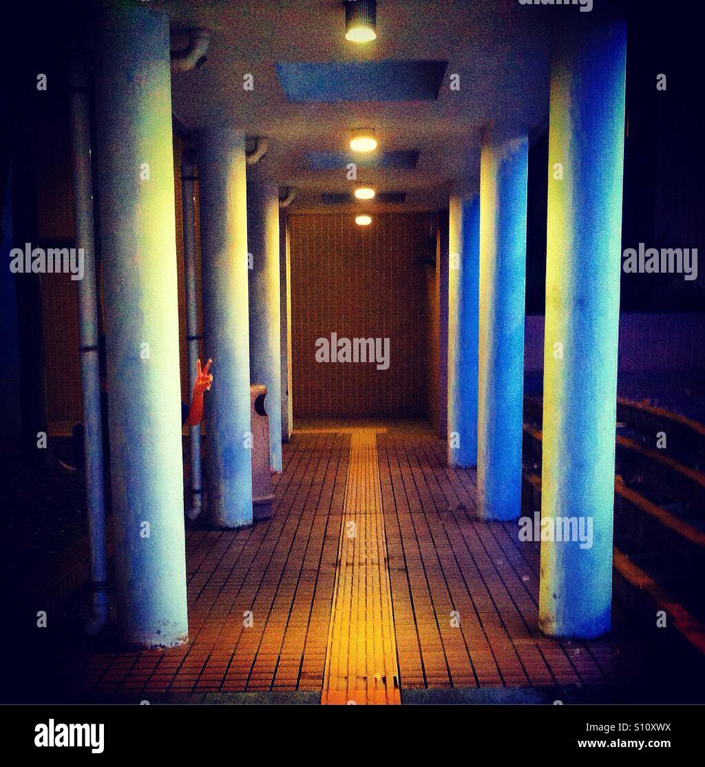 Outdoor corridor with columns. A little arm does the victory sign Stock ...