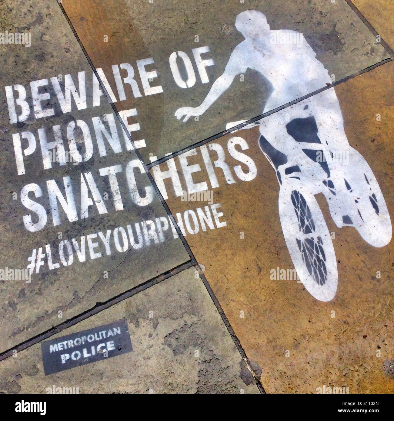 Beware of the Phone Snatchers stencil on a street in central London ...