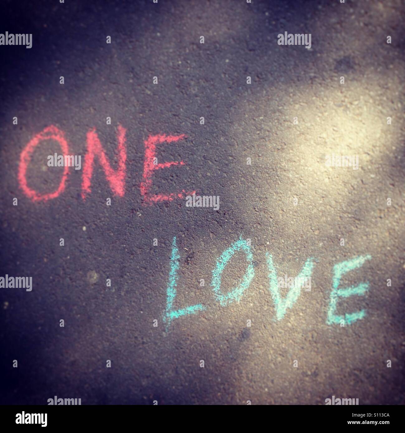 One Love written in chalk on a sidewalk in Berkeley, California Stock ...