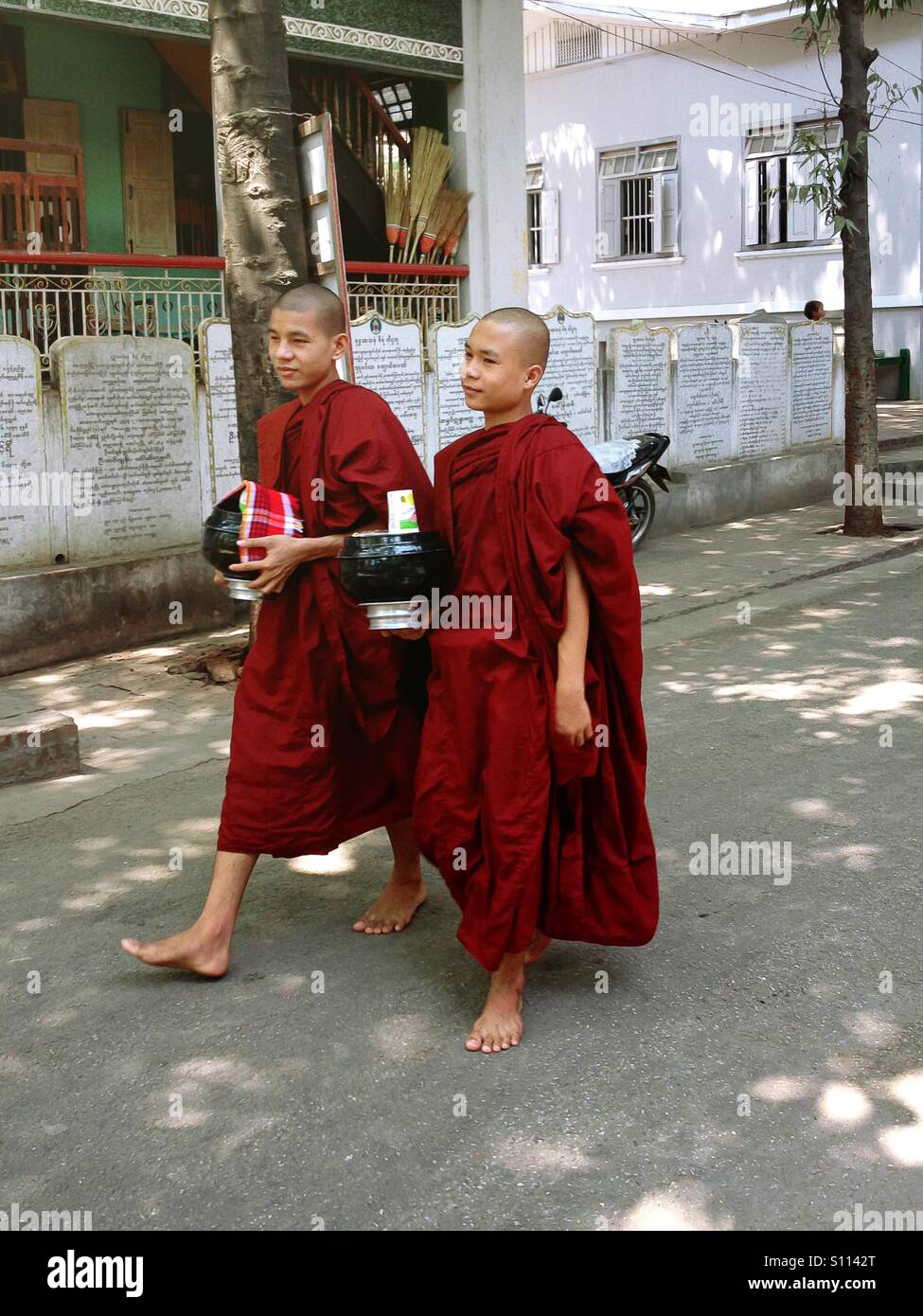 young buddhist novices walk in Mahagandayon monastery near Mandalay ...