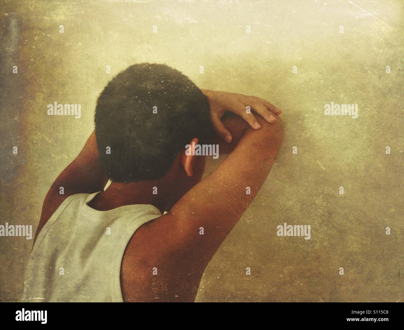 Boy crying against the wall Stock Photo - Alamy