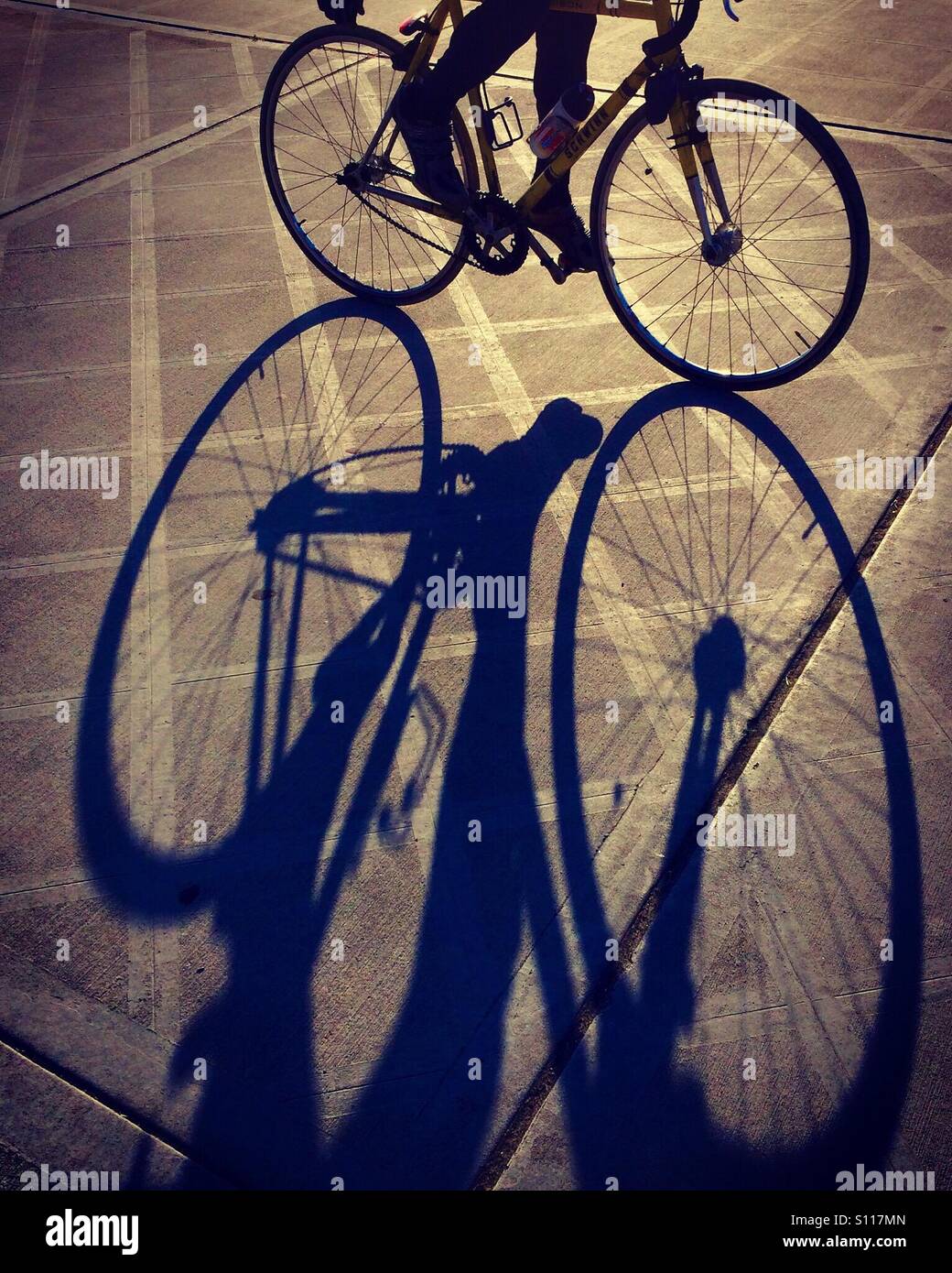 Shadows of bike on pavement hi-res stock photography and images - Alamy