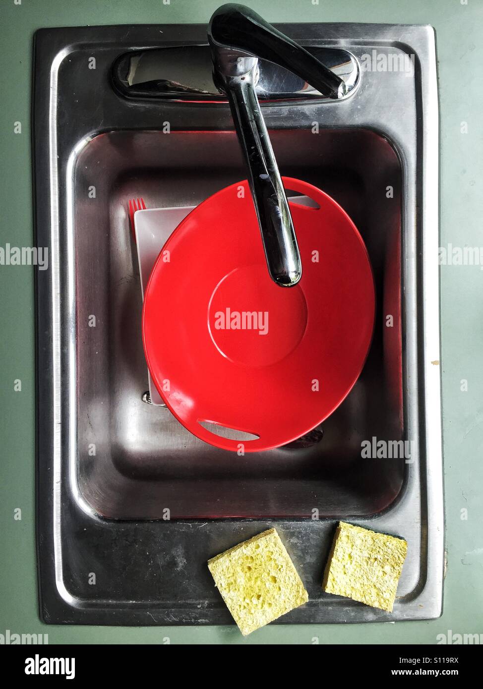 Red bowl in stainless steel sink Stock Photo - Alamy