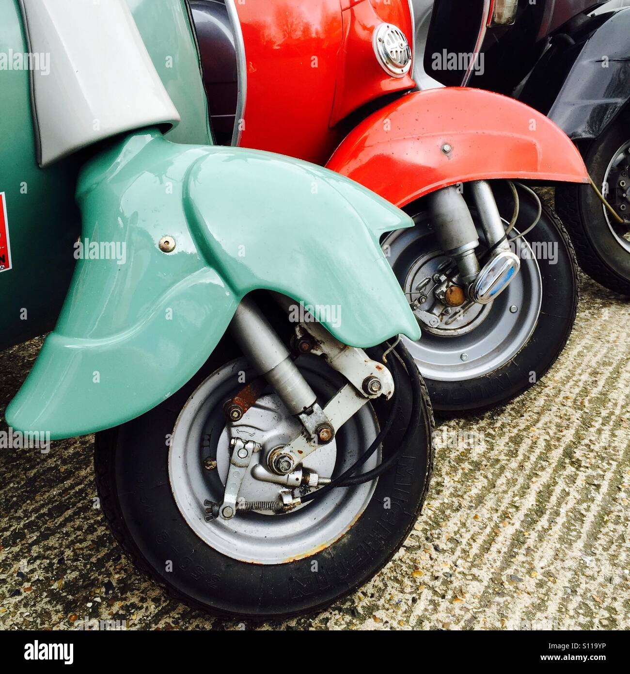 Classic green and red vespa scooters front wheels Stock Photo - Alamy