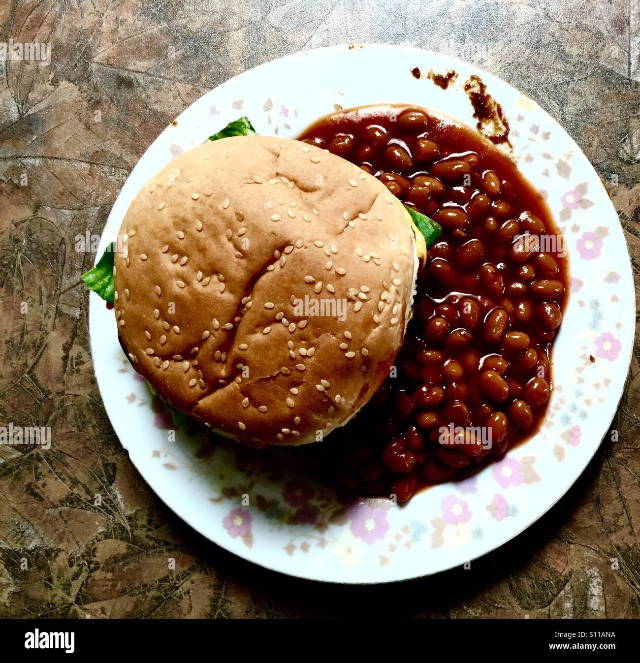 Sesame seed bun and hamburger with beans Stock Photo - Alamy