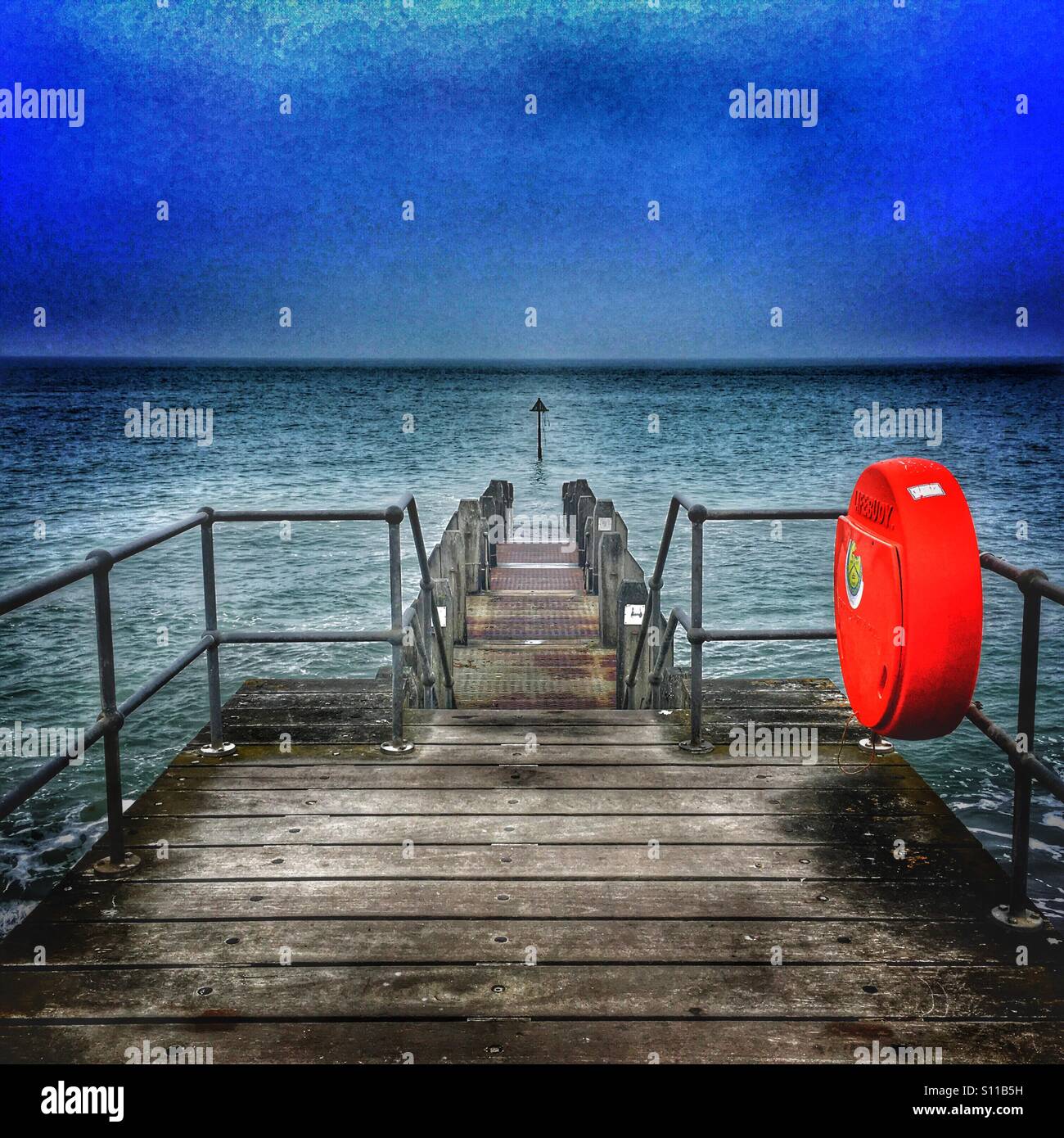 Jetty with lifebuoy Stock Photo - Alamy