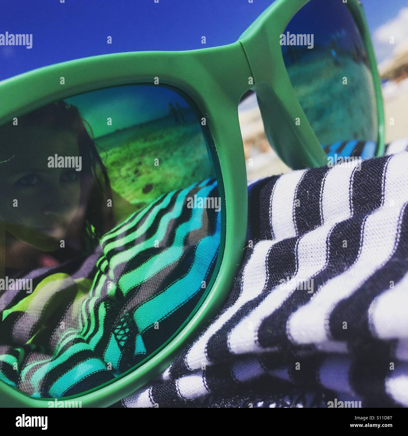 Young woman's reflection in sunglasses on the beach Stock Photo - Alamy