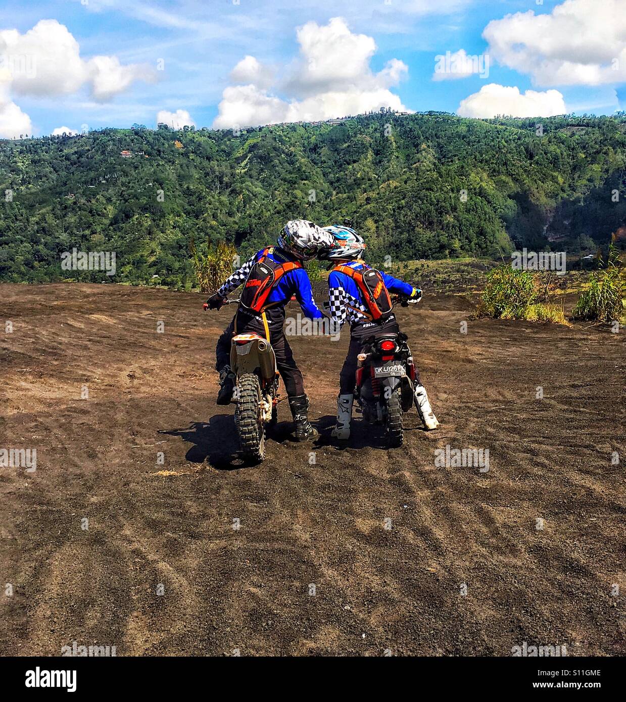 Couple doing a 'helmet kiss' while out riding a volcano in Bali Stock ...