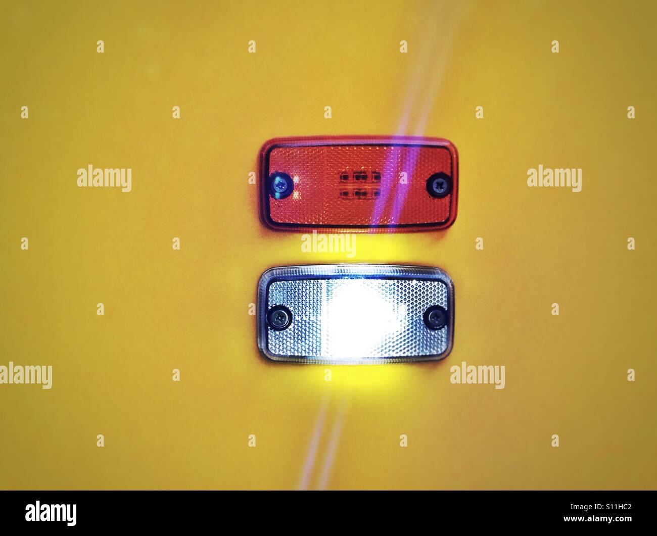 Two backlights on a yellow background Stock Photo - Alamy