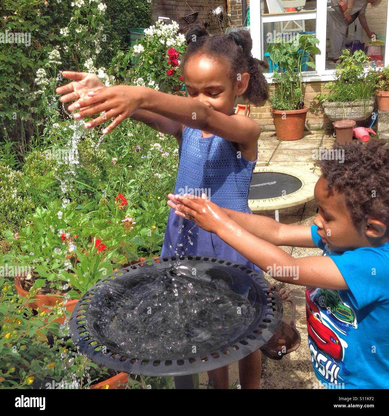 Children playing with water Stock Photo - Alamy