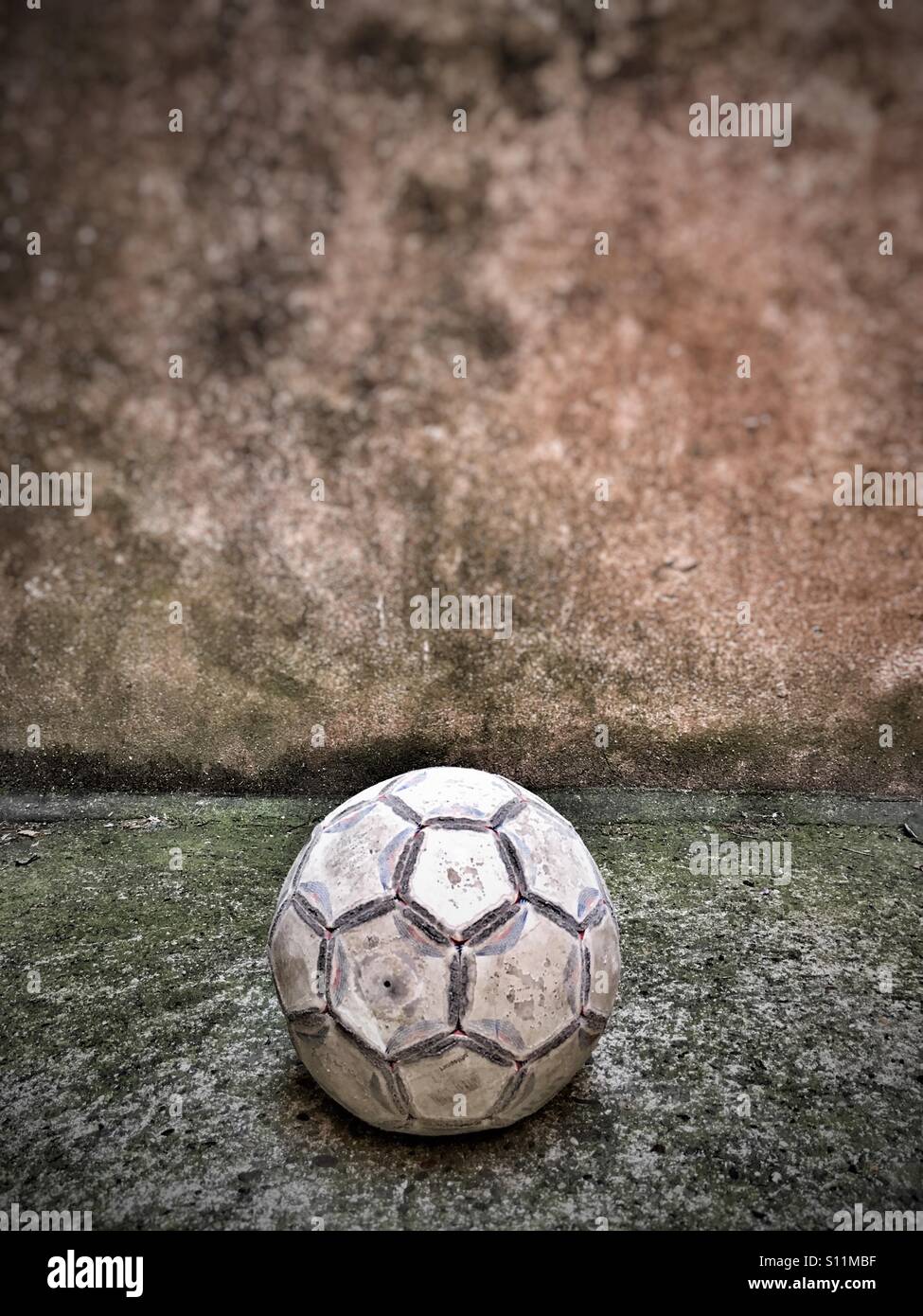 Soccer ball against a wall Stock Photo - Alamy