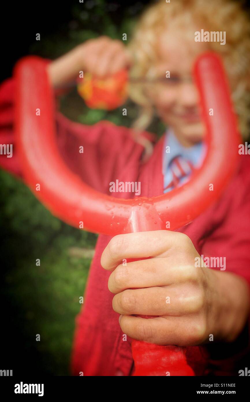 Young girl playing with toy catapult Stock Photo - Alamy