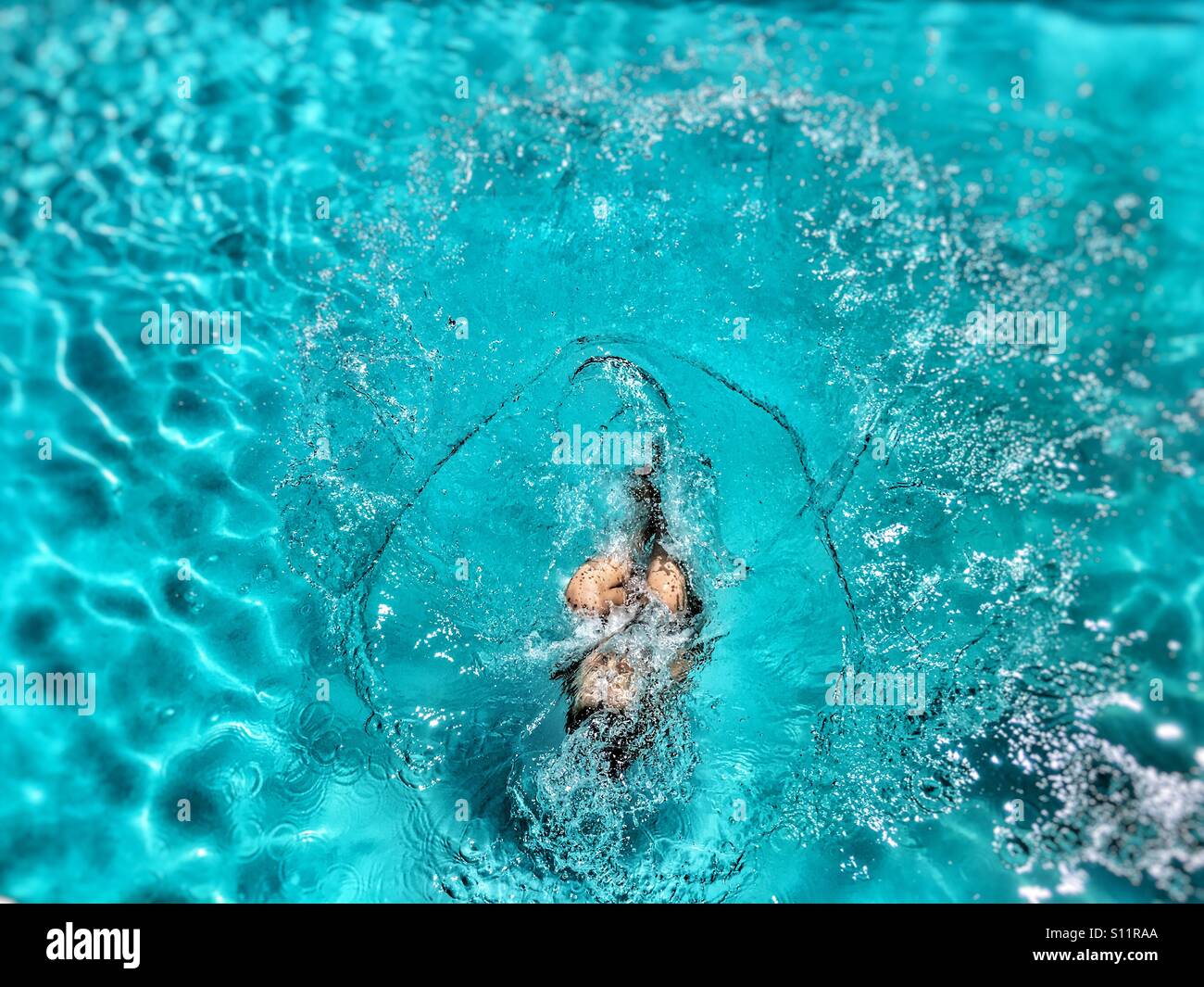 Child jumping into a swimming pool Stock Photo - Alamy