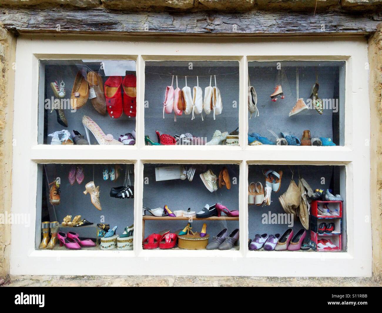 Miniature shoes in a window display Stock Photo - Alamy