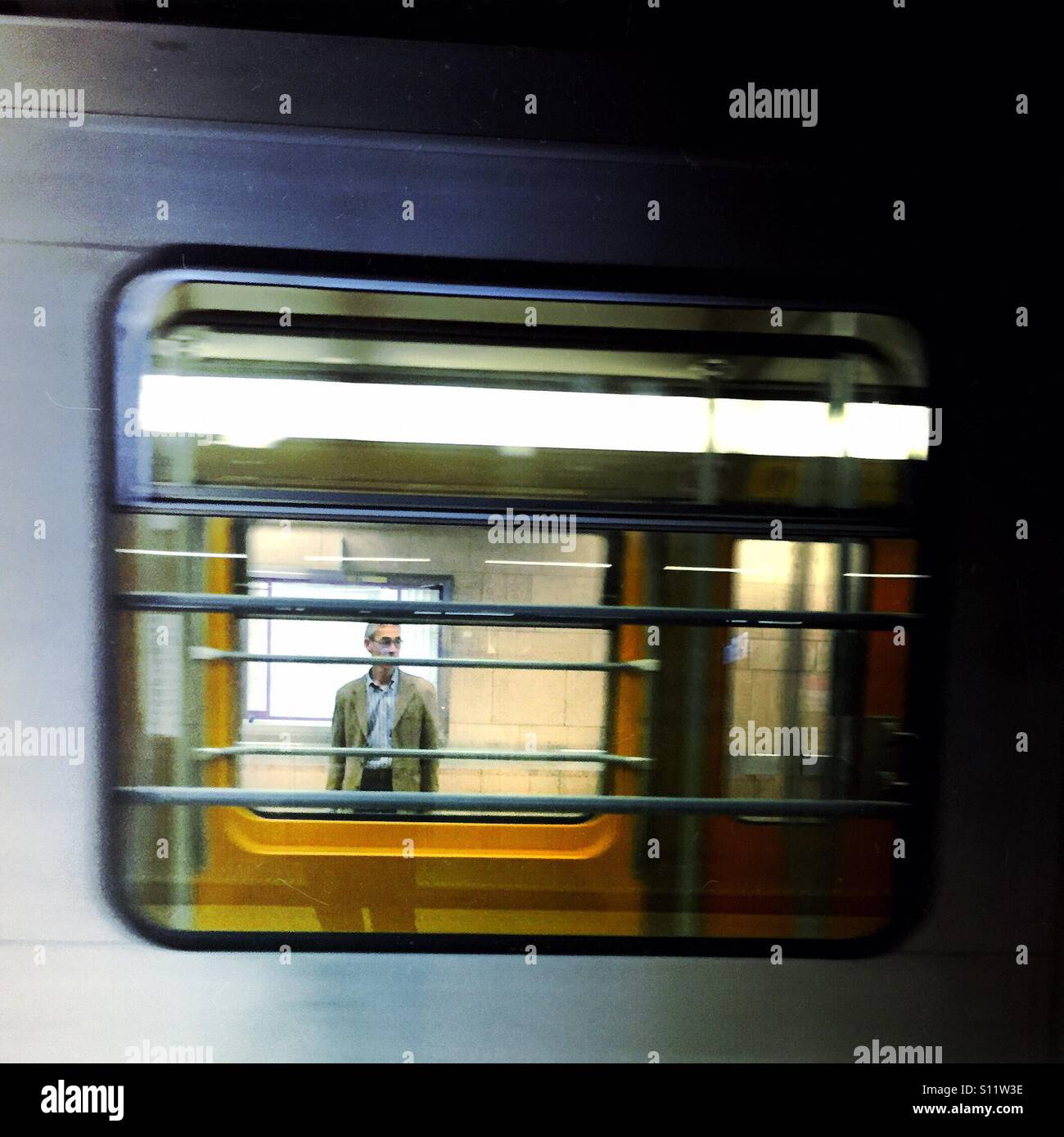 Window into the soul. Man seen through the windows of a subway car ...