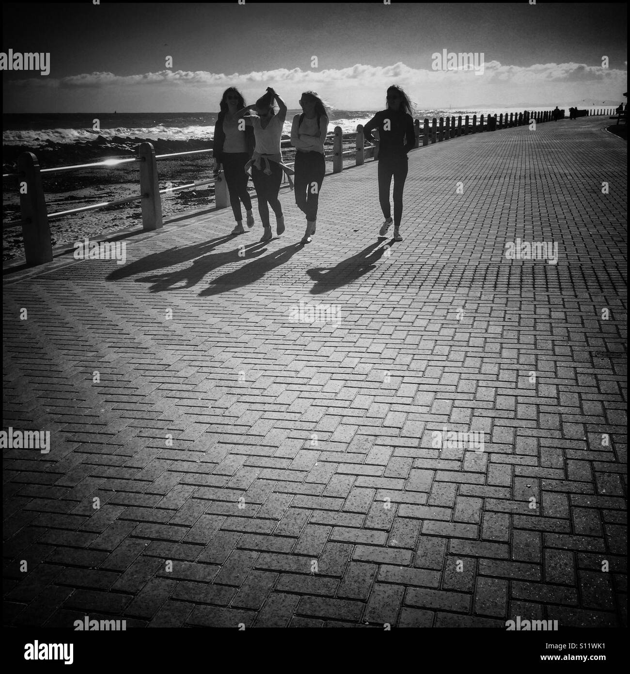 Group of young women walking along the Seapoint promenade in Cape Town ...