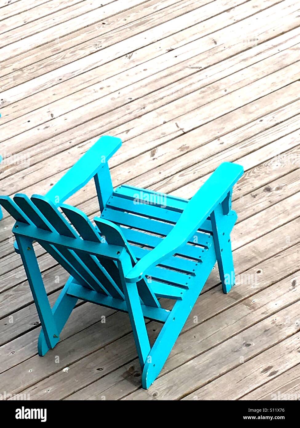 Blue Adirondack chair on a dock Stock Photo - Alamy