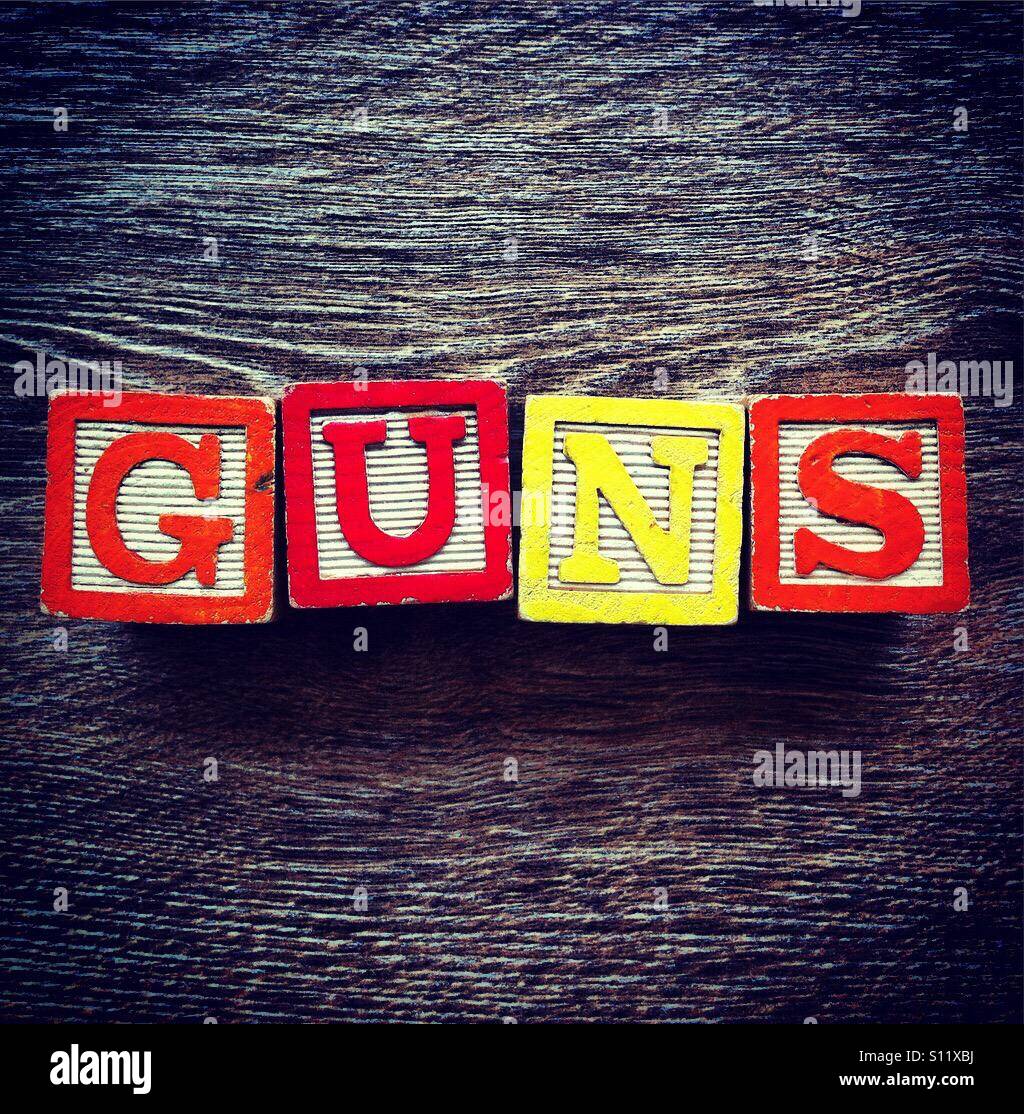 GUNS word done with wood blocks letters Stock Photo - Alamy