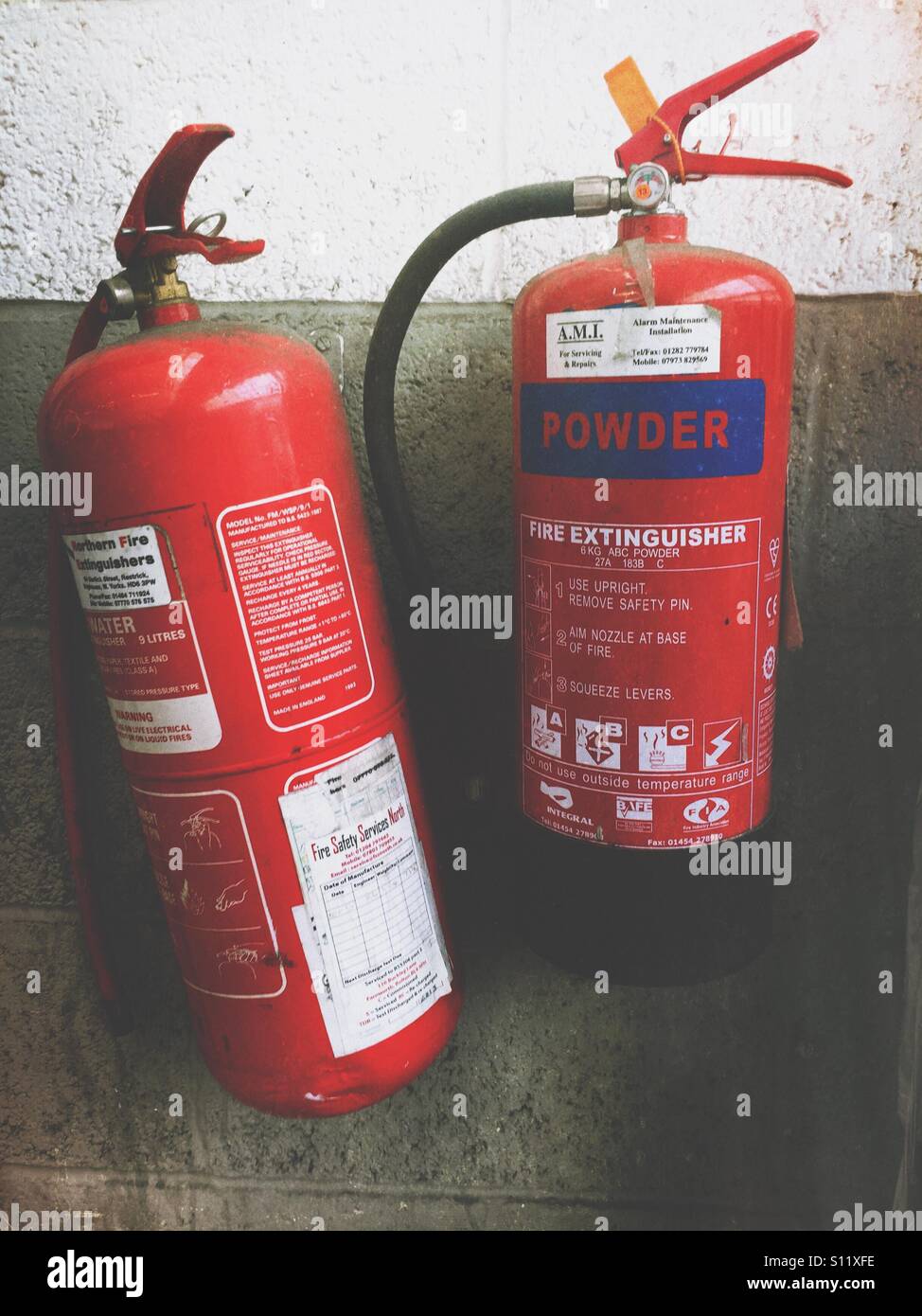 Two fire extinguishers on the wall Stock Photo - Alamy