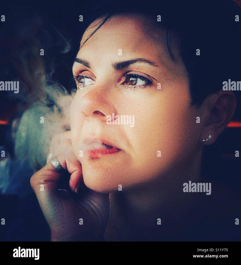 Beautiful woman vaping Stock Photo - Alamy
