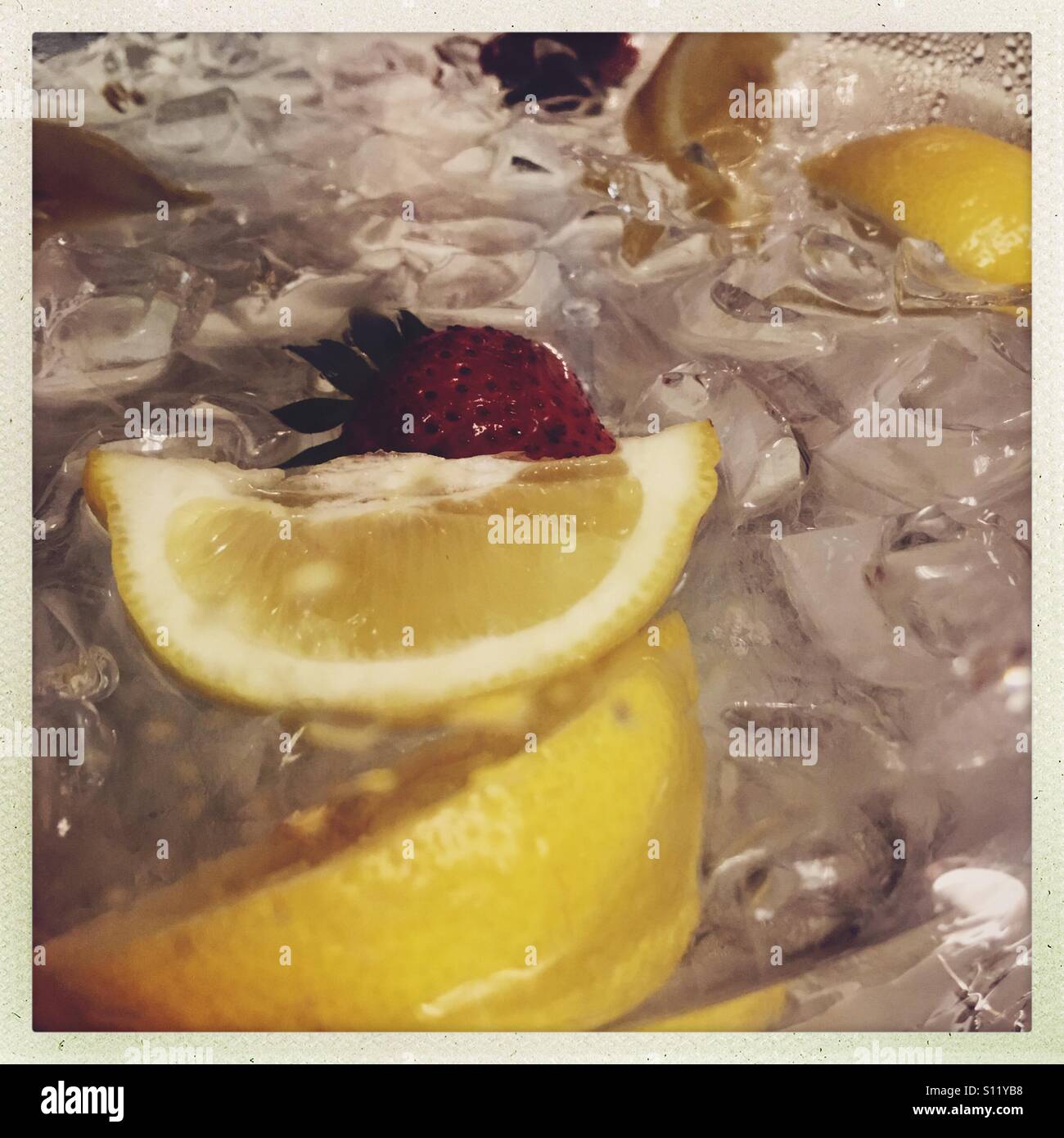 Fruit floating in ice water Stock Photo - Alamy