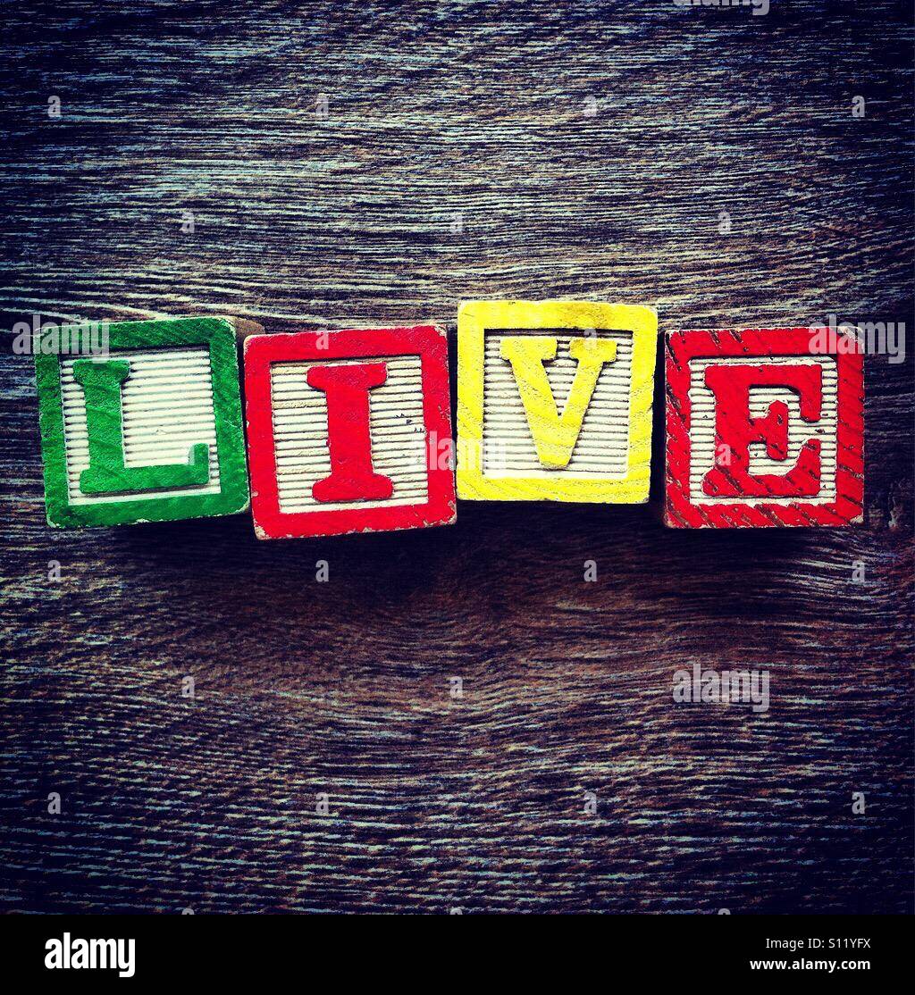 LIVE word done with alphabet wood blocks letters Stock Photo - Alamy