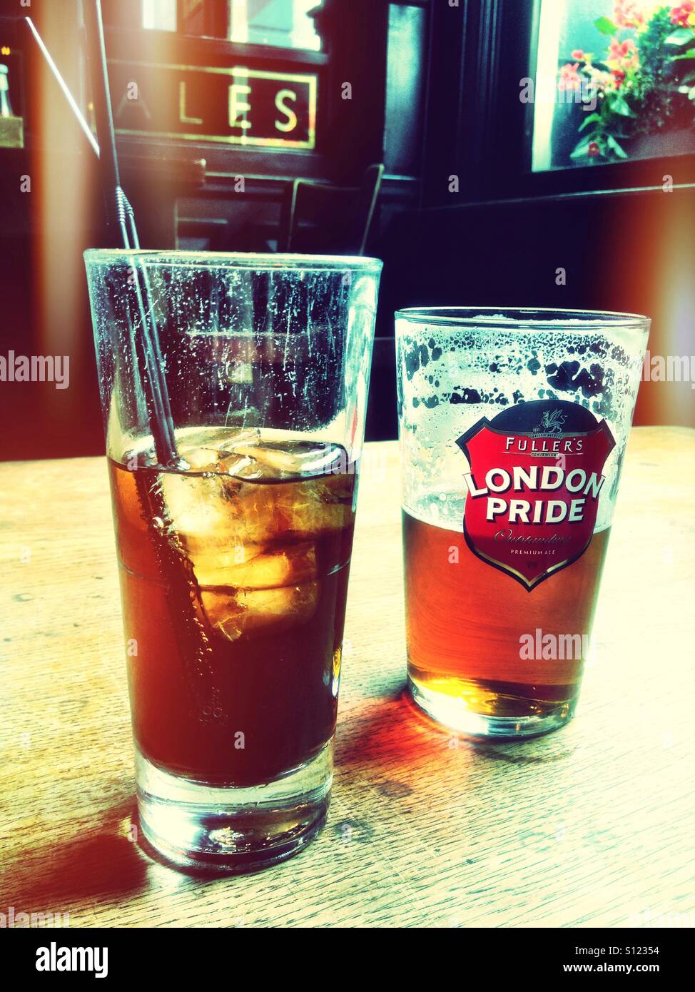 A pint of beer and a glass of cola Stock Photo - Alamy