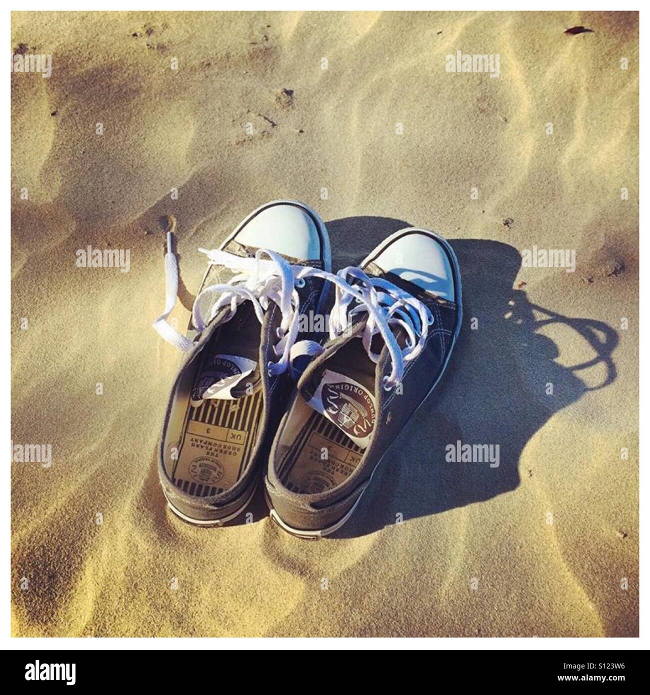 Shoes on sand Stock Photo - Alamy