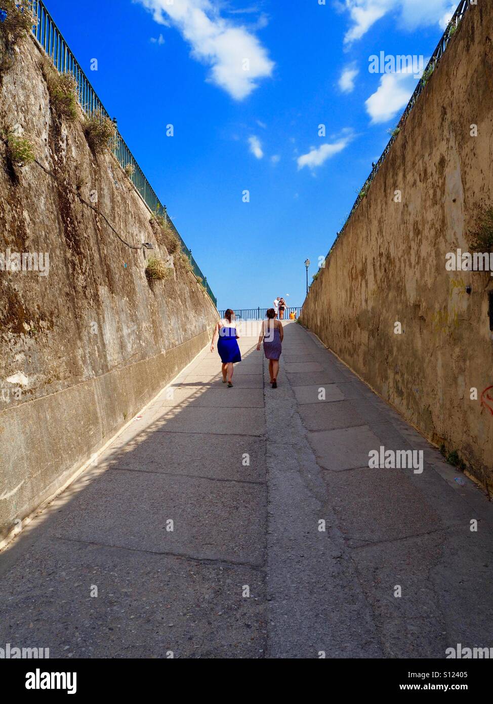 Two girls walking together hi-res stock photography and images - Alamy