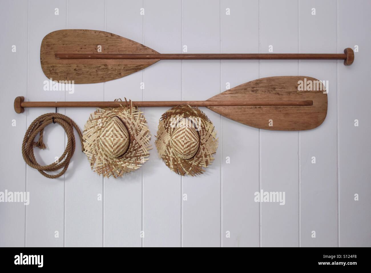 Vintage equipment. paddle rope and hat hang on the white wall Stock ...