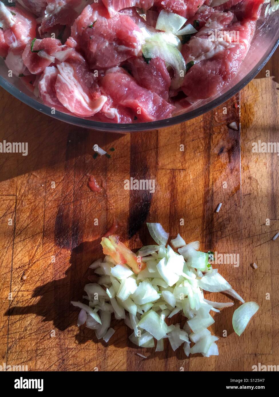 Onions and meat being prepared to be cooked on a plancha (Spanish BBQ ...