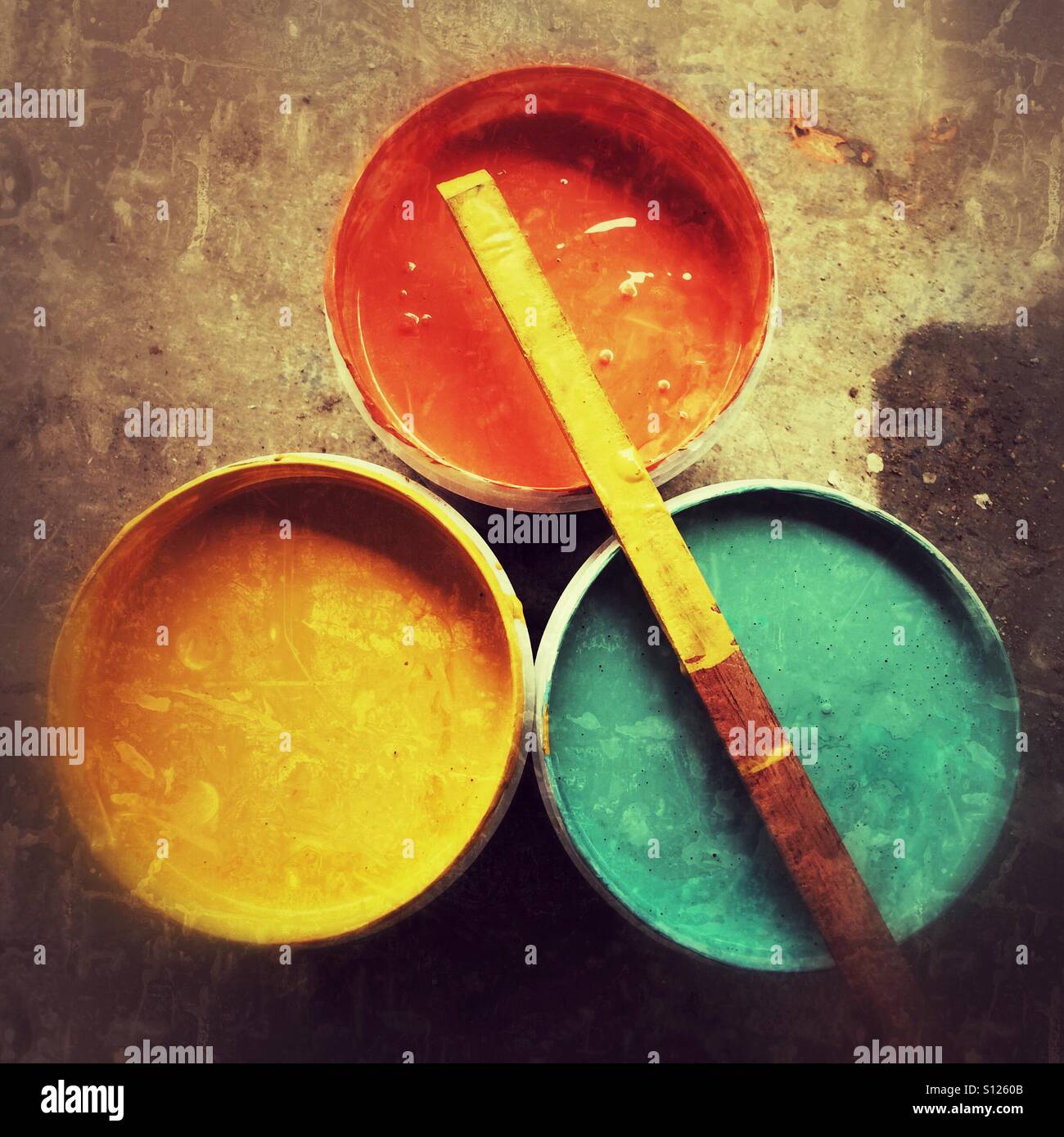 Three cans of paints of different colours Stock Photo - Alamy