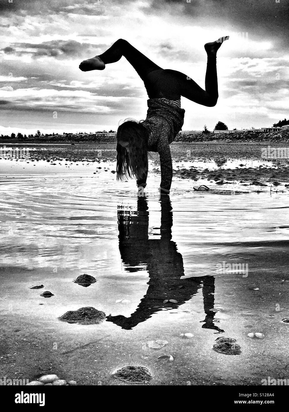 Handstand on beach Stock Photo - Alamy
