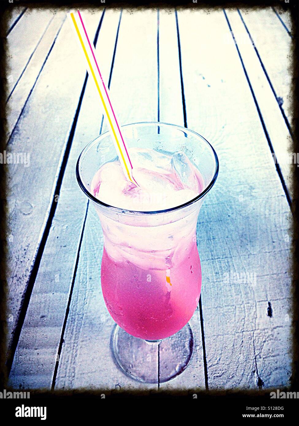 Pink color cocktail with ice and straw Stock Photo - Alamy