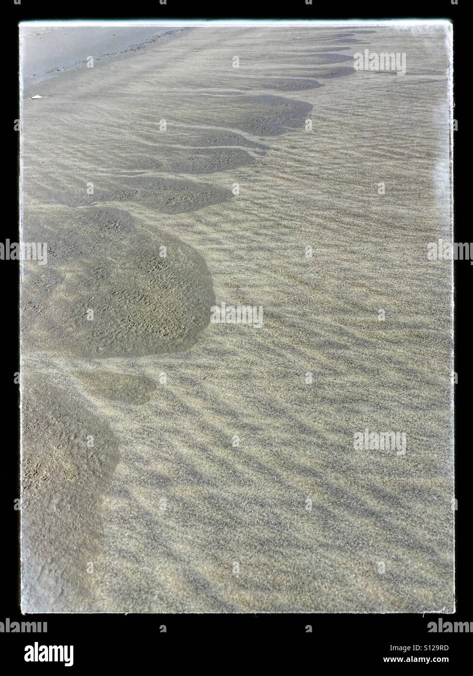 Waves receding on the beach Stock Photo - Alamy