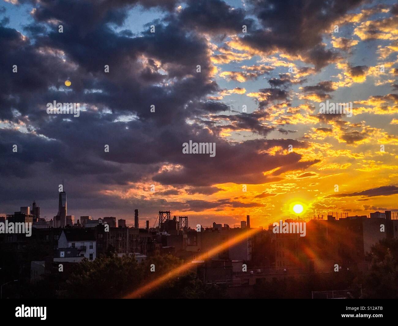 Sunlight peering through a sunset in New York City. View from a window ...