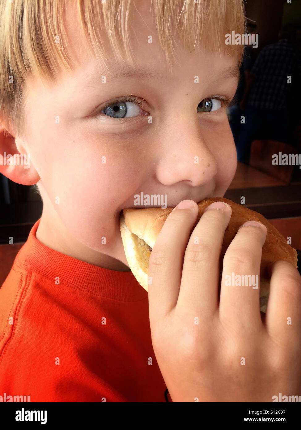 Boy eating burger hi-res stock photography and images - Alamy