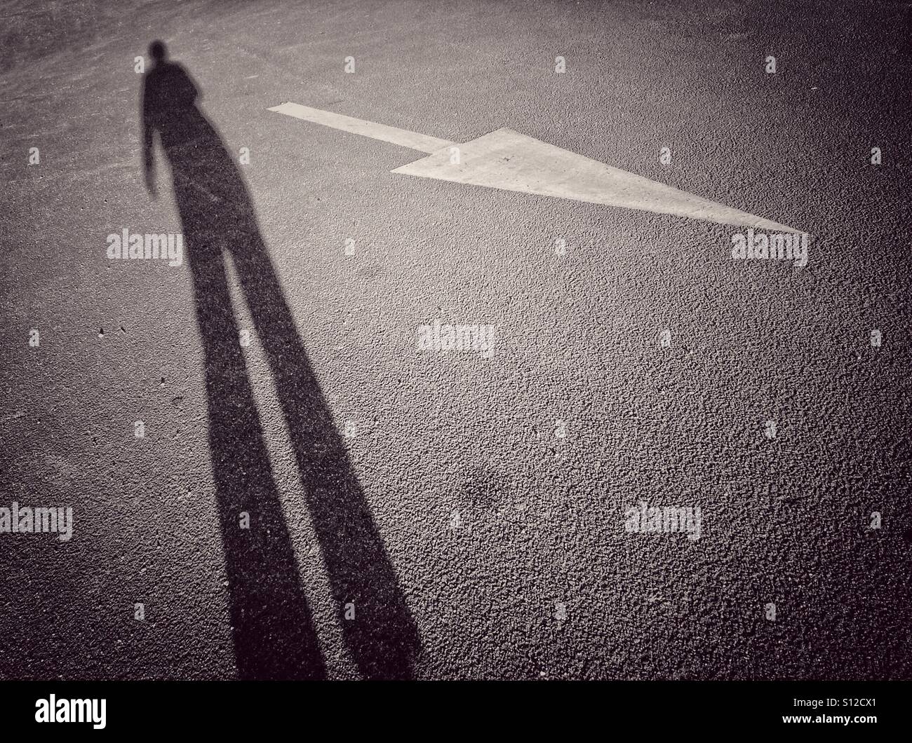 Pedestrian shadowy and arrow sign on asphalt Stock Photo - Alamy