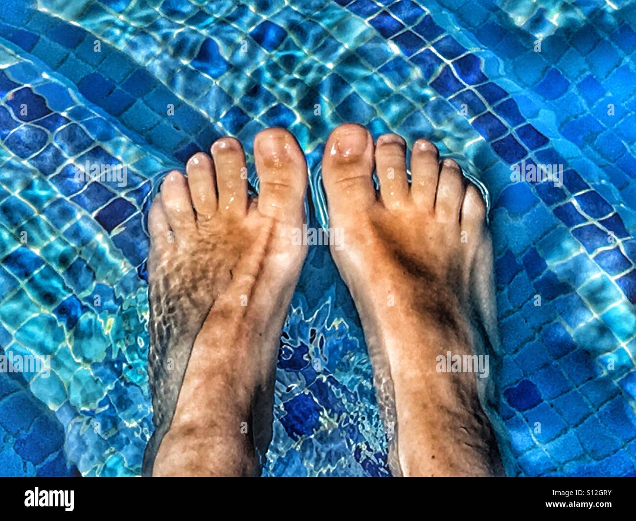Pov feet in swimming pool hi-res stock photography and images - Alamy