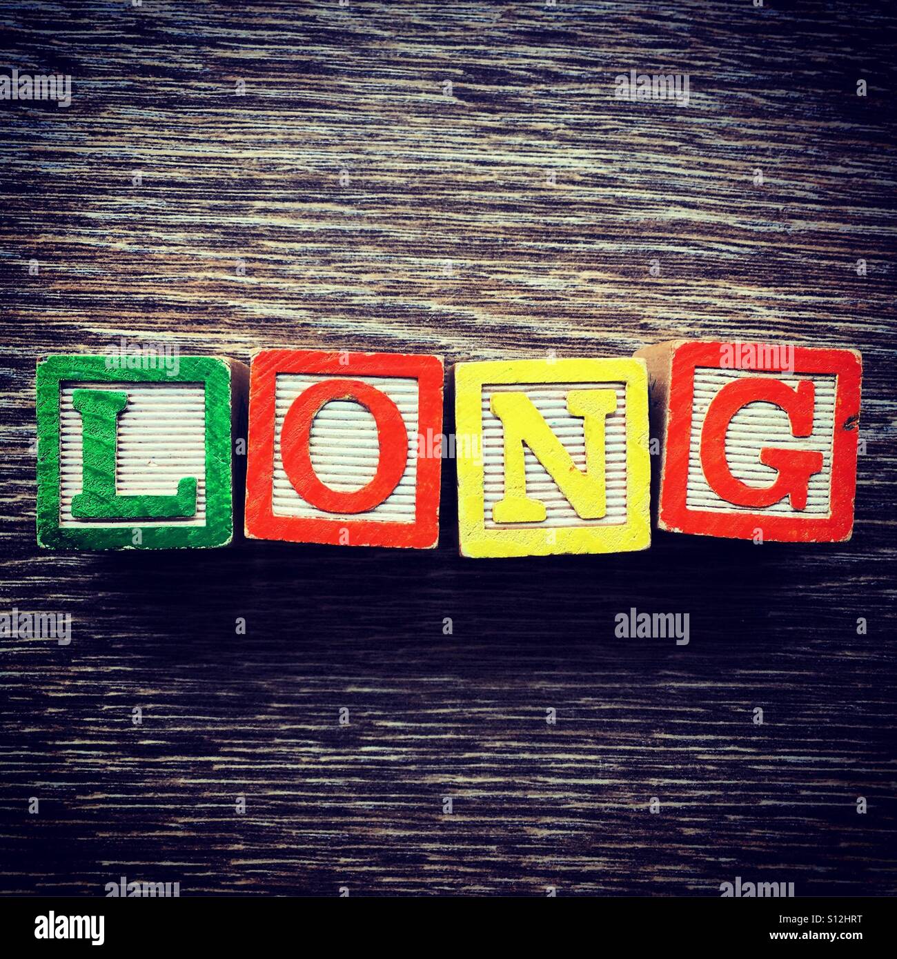 LONG word written with wood block letter toys Stock Photo - Alamy