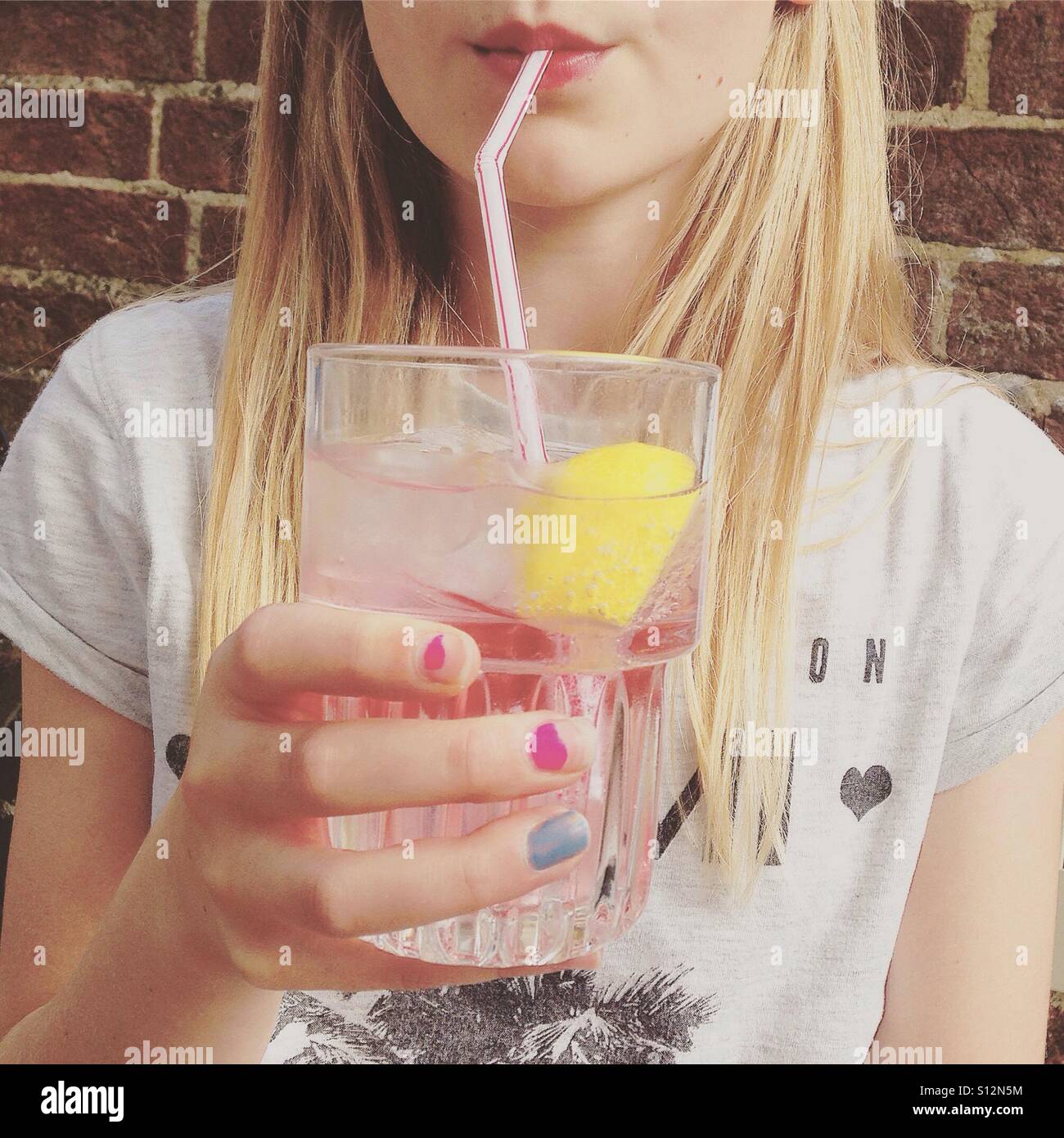 Young Teen sipping Lemonade Stock Photo - Alamy